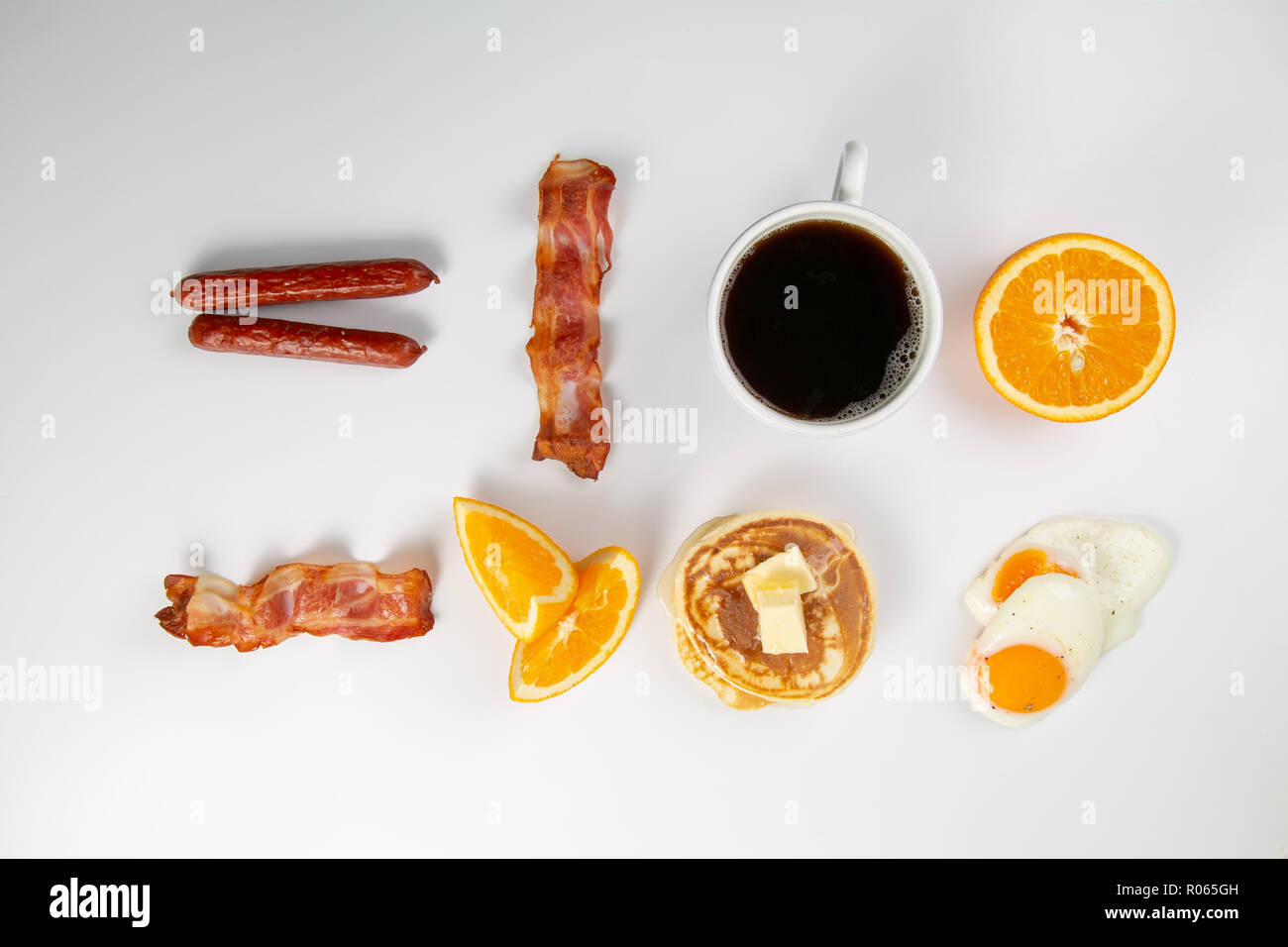 Creative layout - breakfast essentials - eggs, pancakes, bacon, on ...