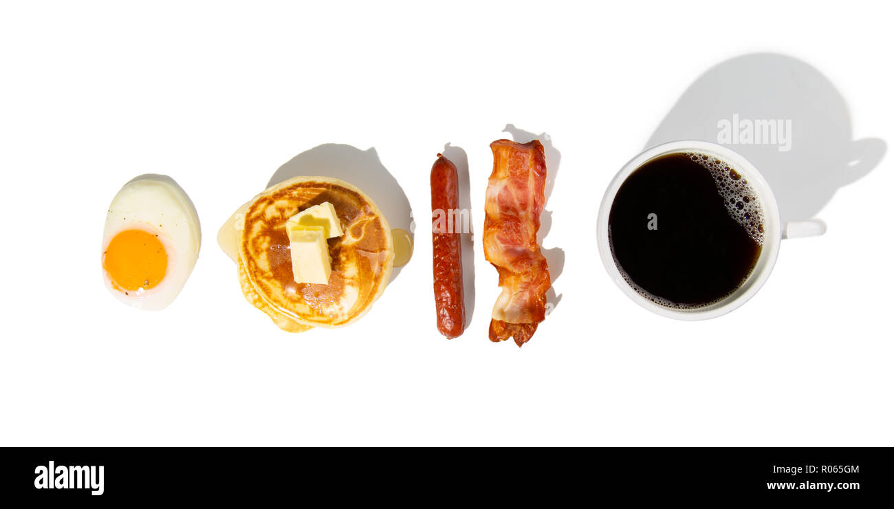 Creative layout - breakfast essentials - eggs, pancakes, bacon, on ...