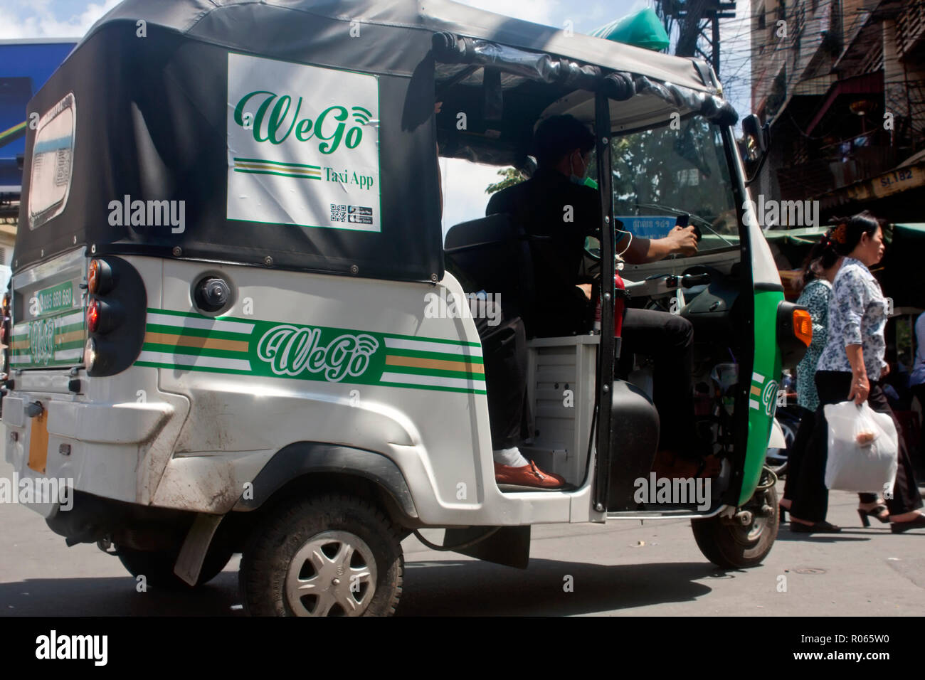 A WeGo taxi that can be booked by mobile phone is driving on a city ...