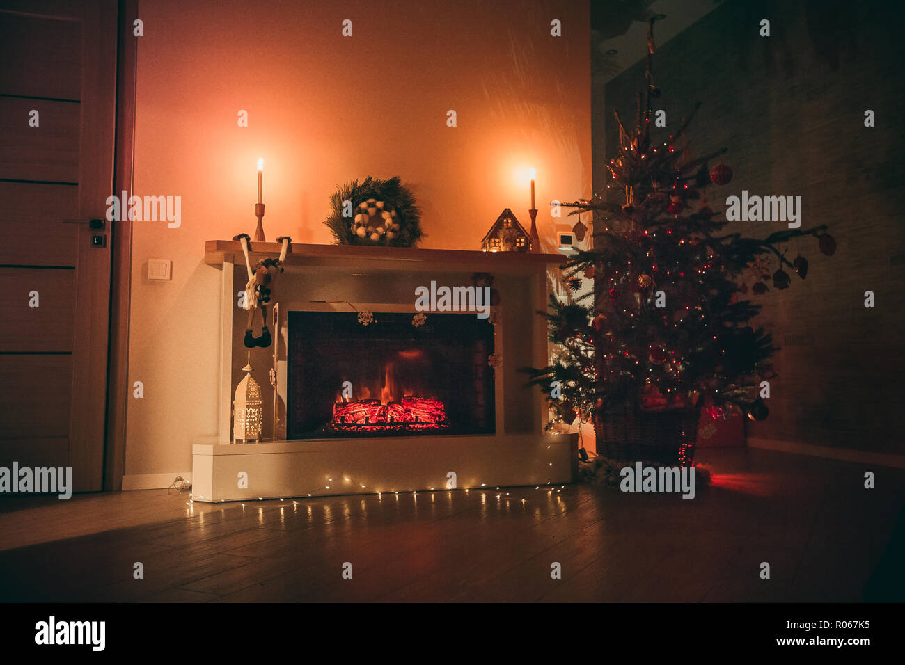Beautiful decorated fireplace and Christmas tree background. Merry ...