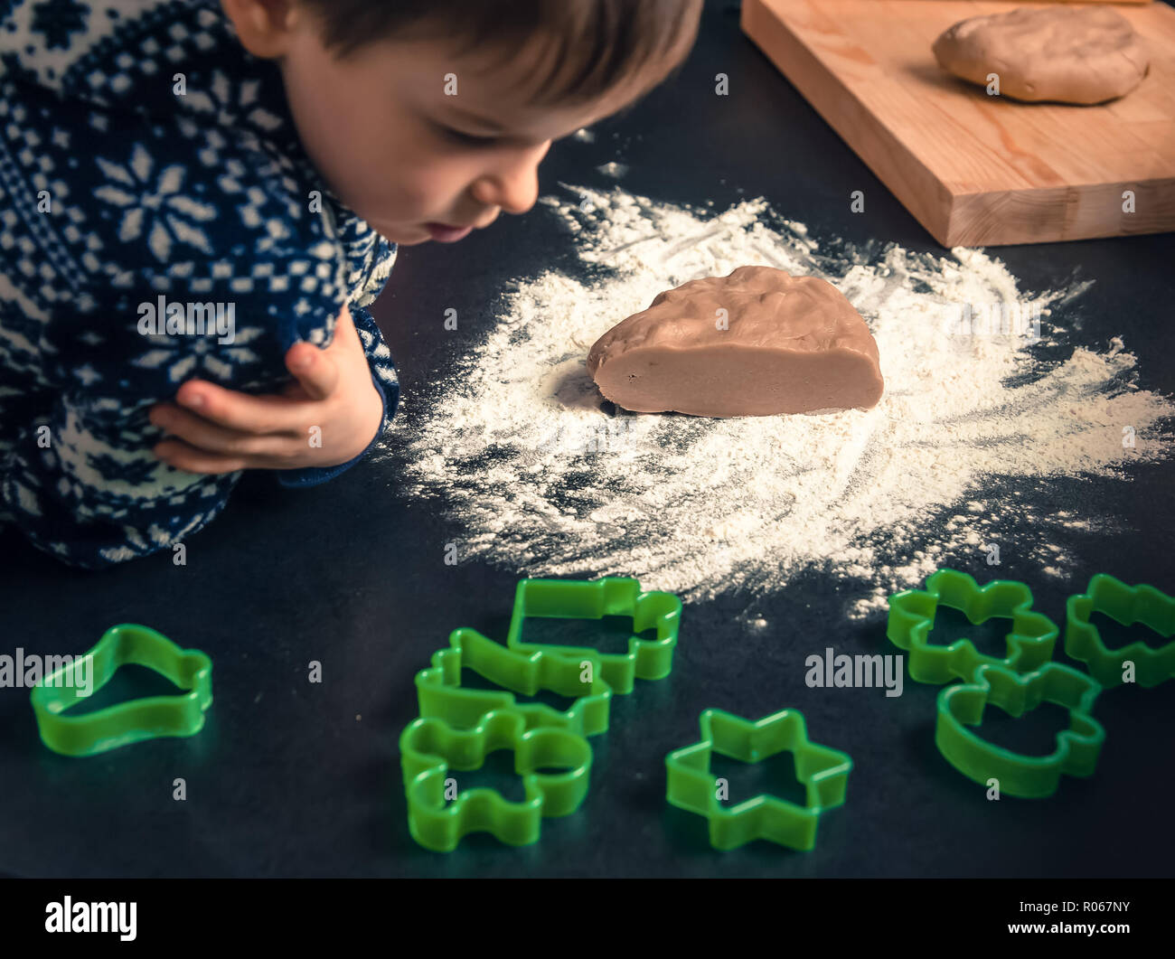 Happy Child cooking in the kitchen. Little boy helping mother to ...