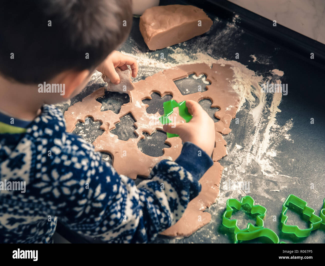 Happy Child cooking in the kitchen. Little boy helping mother to ...