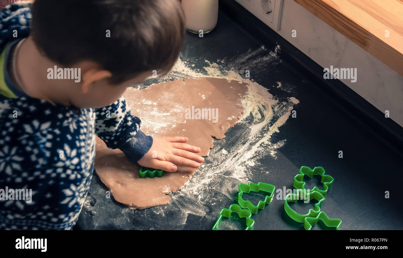 Happy Child cooking in the kitchen. Little boy helping mother to ...