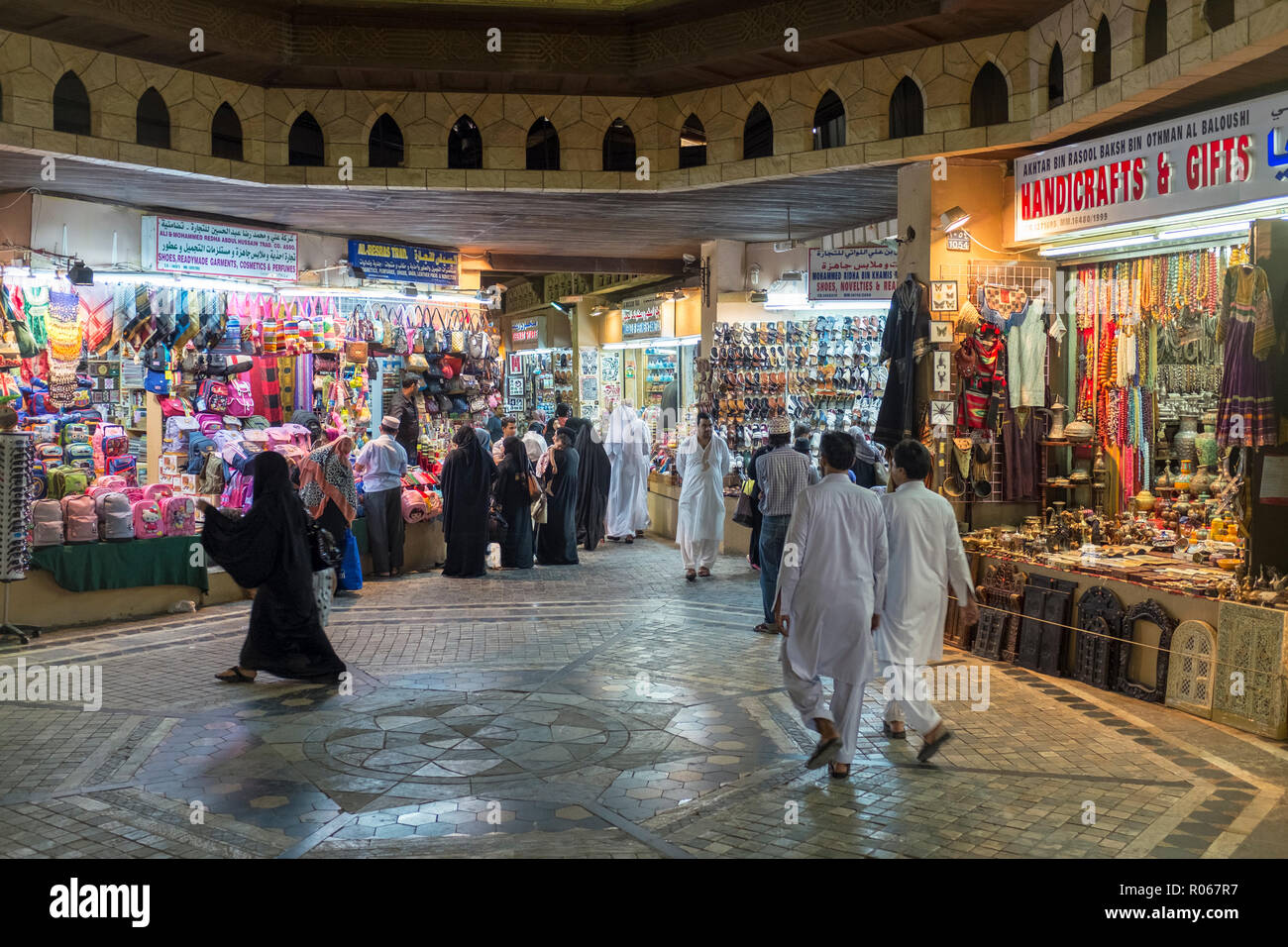 Shoppers at the souk at Muttrah Corniche, Muscat, Oman. This historic ...