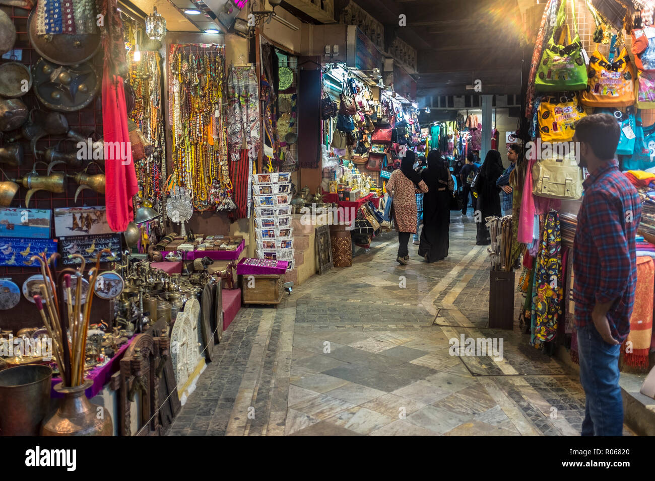 Shoppers at the souk at Muttrah Corniche, Muscat, Oman. This historic ...