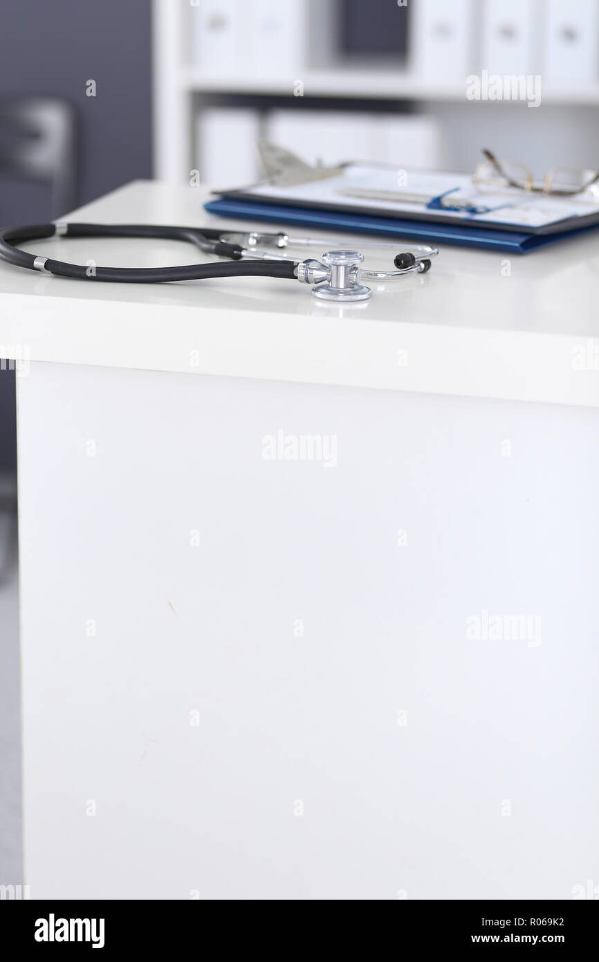 Stethoscope and medical history form lying at reception desk. Medical ...