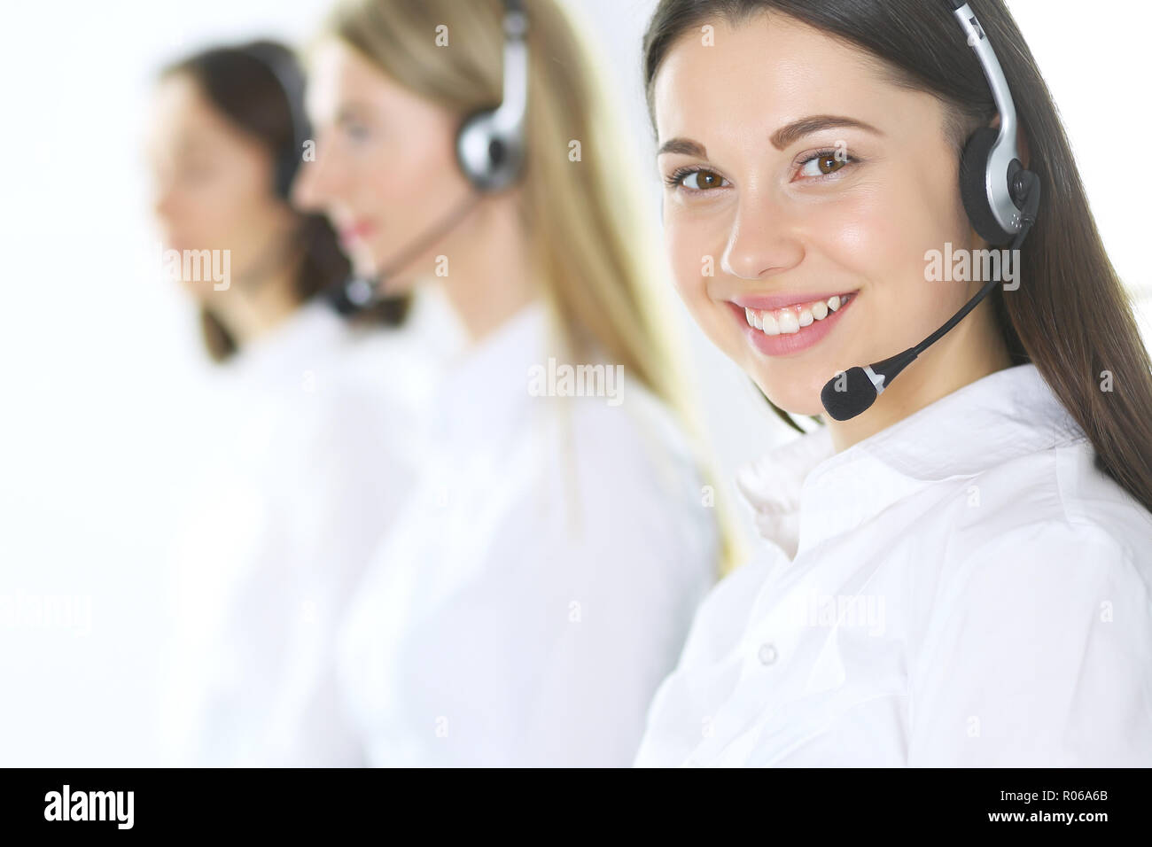 Group of call center operators at work. Focus at beautiful business ...