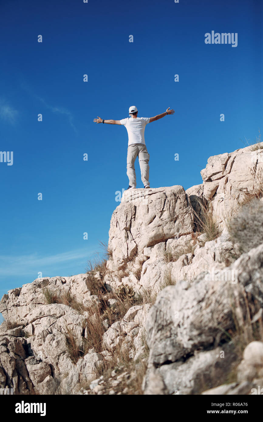 Young male rock climber on a cliff top Stock Photo - Alamy