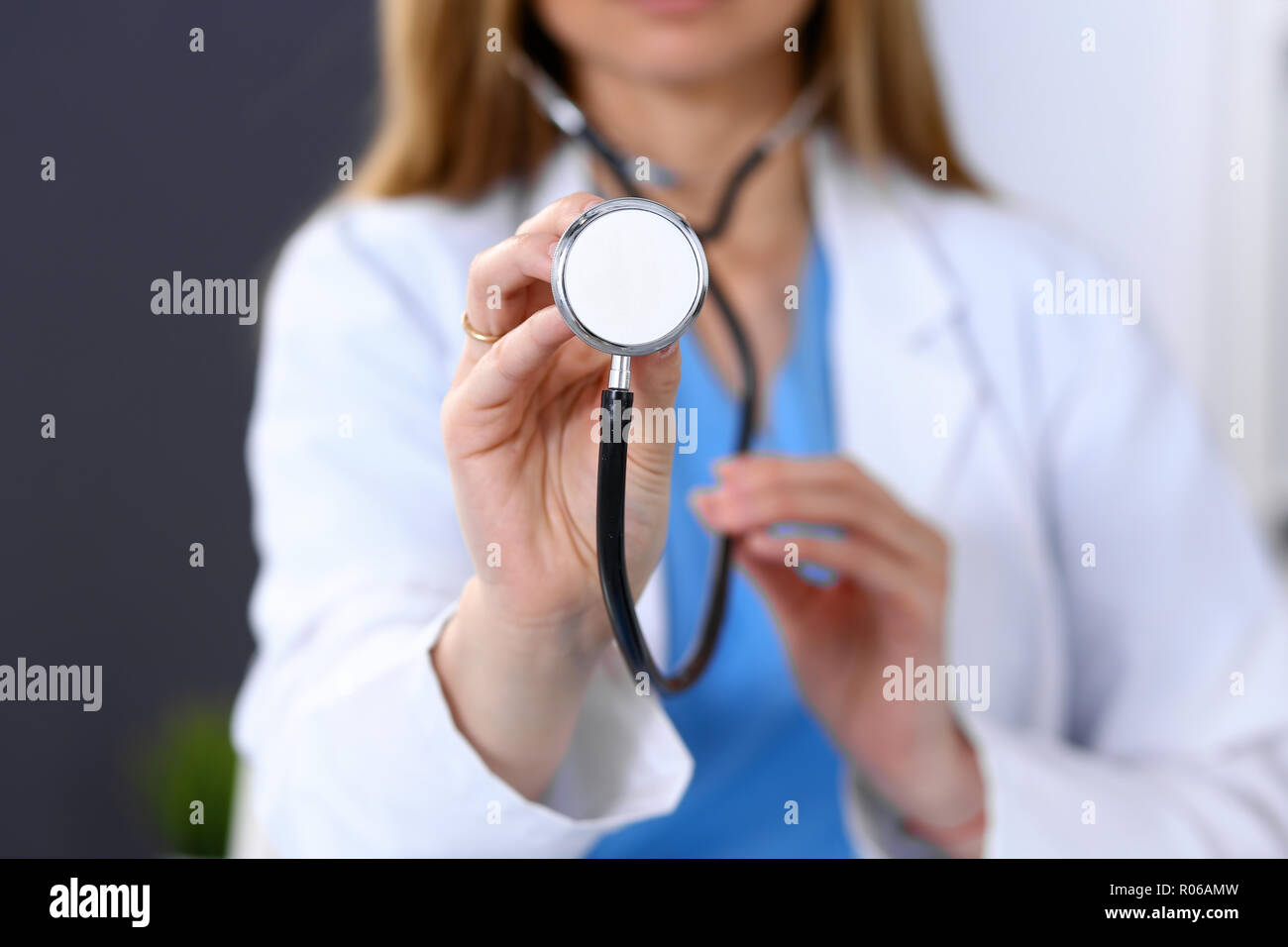 Doctor holds stethoscope head, close-up. Medical help and insurance in ...