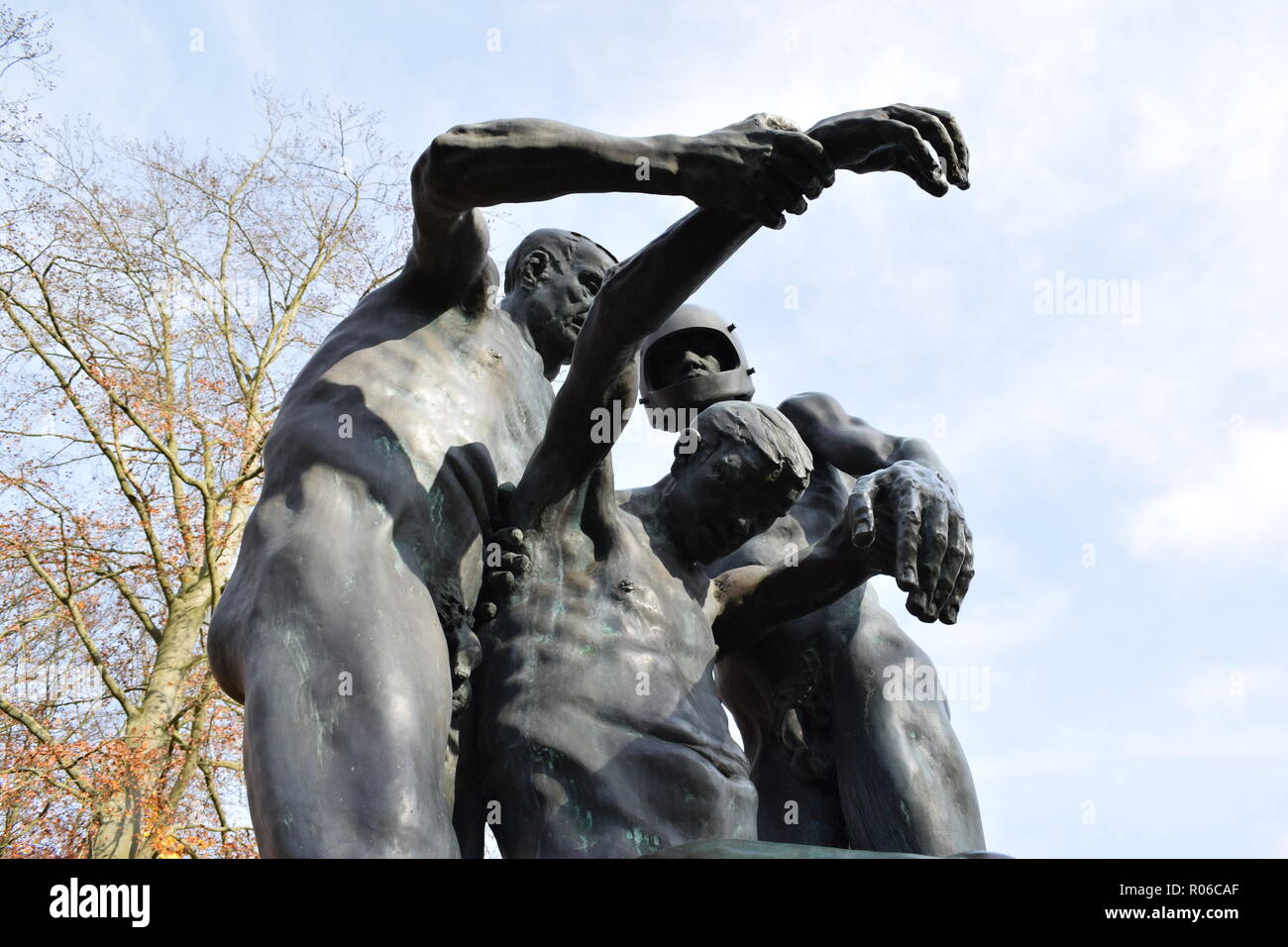 A bronze statue in Autumn in the War Cemetery in Reimsbach depicts two ...