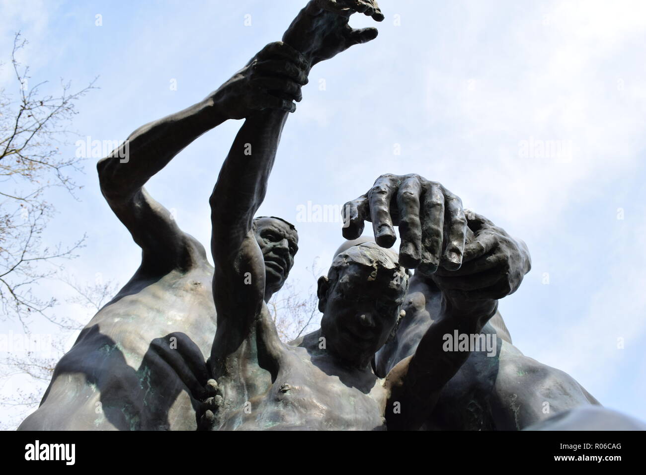 A bronze statue in Autumn in the War Cemetery in Reimsbach depicts two ...