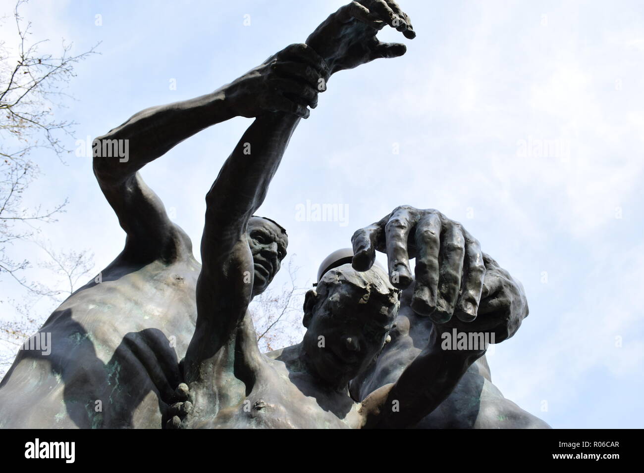 A bronze statue in Autumn in the War Cemetery in Reimsbach depicts two ...