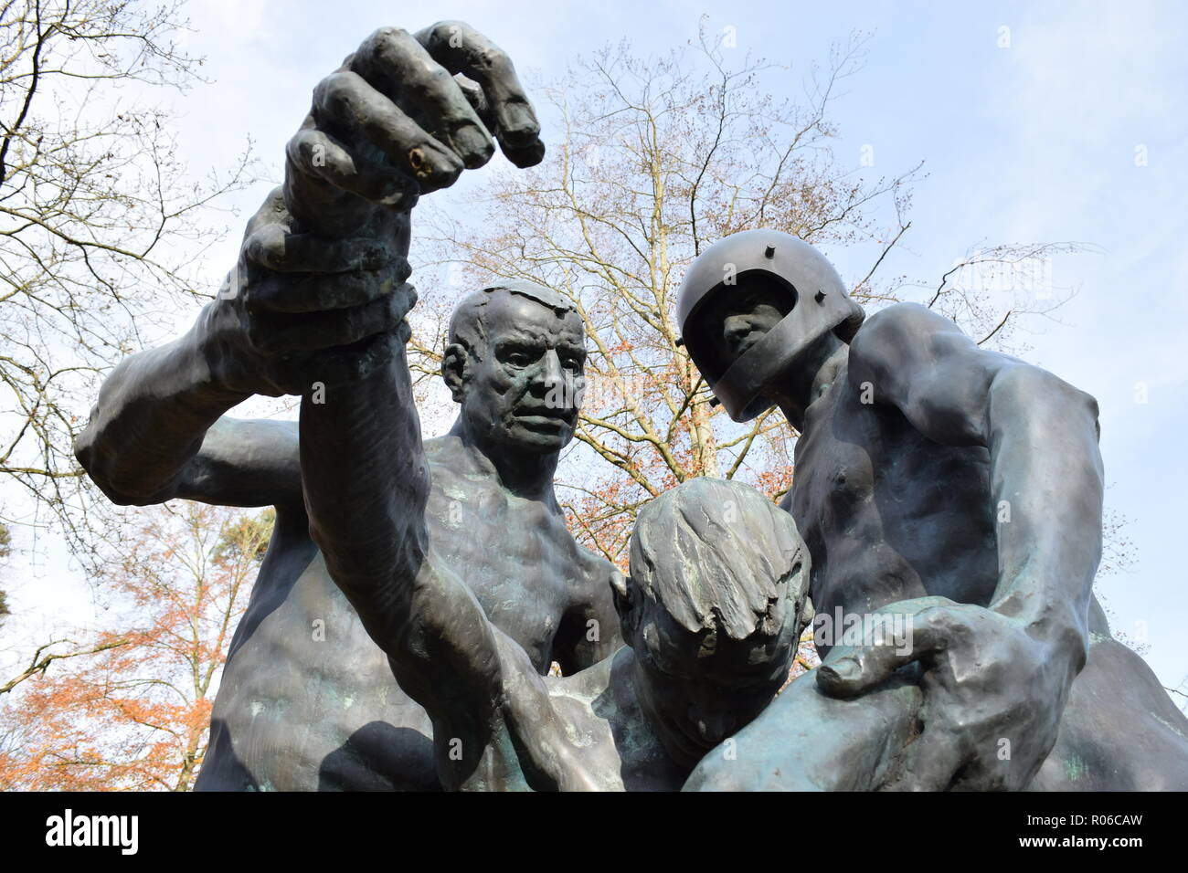 A bronze statue in Autumn in the War Cemetery in Reimsbach depicts two ...