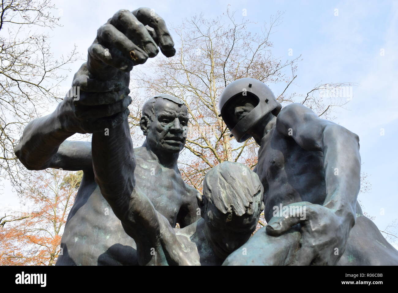 A bronze statue in Autumn in the War Cemetery in Reimsbach depicts two ...