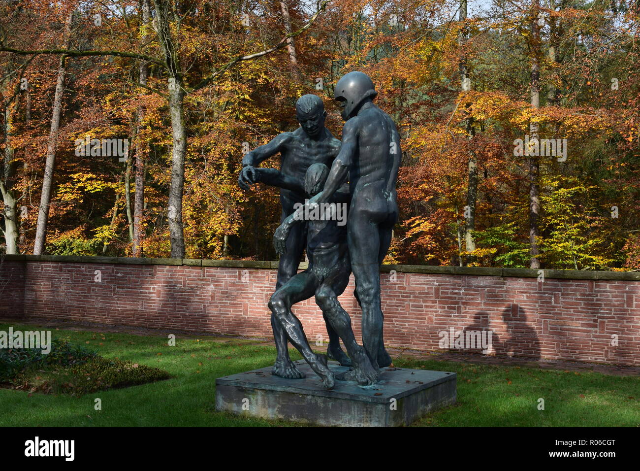 A bronze statue in Autumn in the War Cemetery in Reimsbach depicts two ...