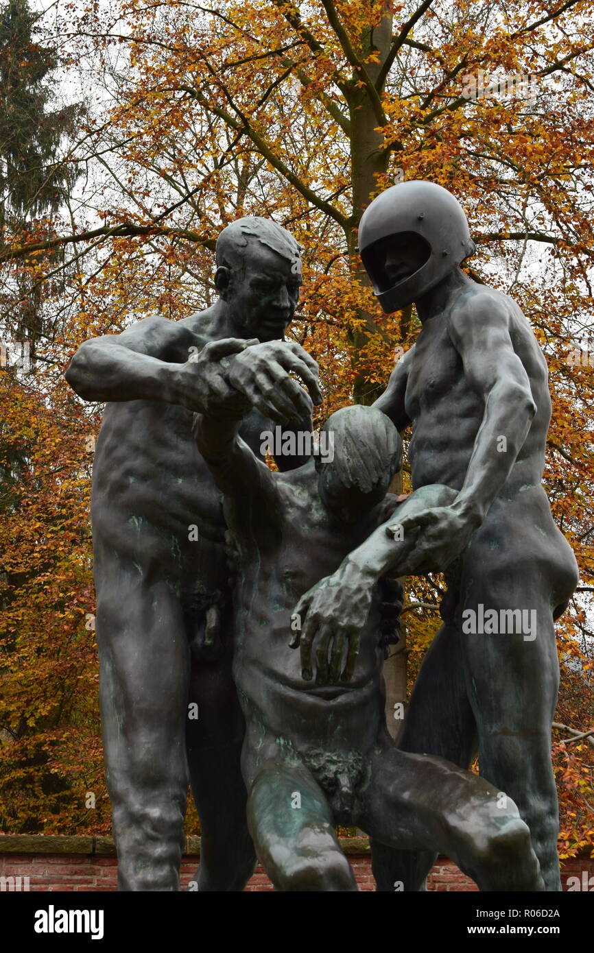 A bronze statue in Autumn in the War Cemetery in Reimsbach depicts two ...