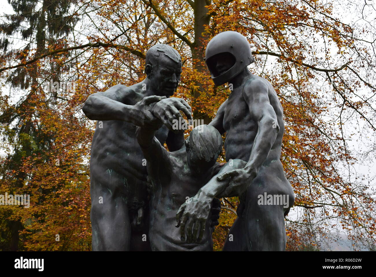 A bronze statue in Autumn in the War Cemetery in Reimsbach depicts two ...
