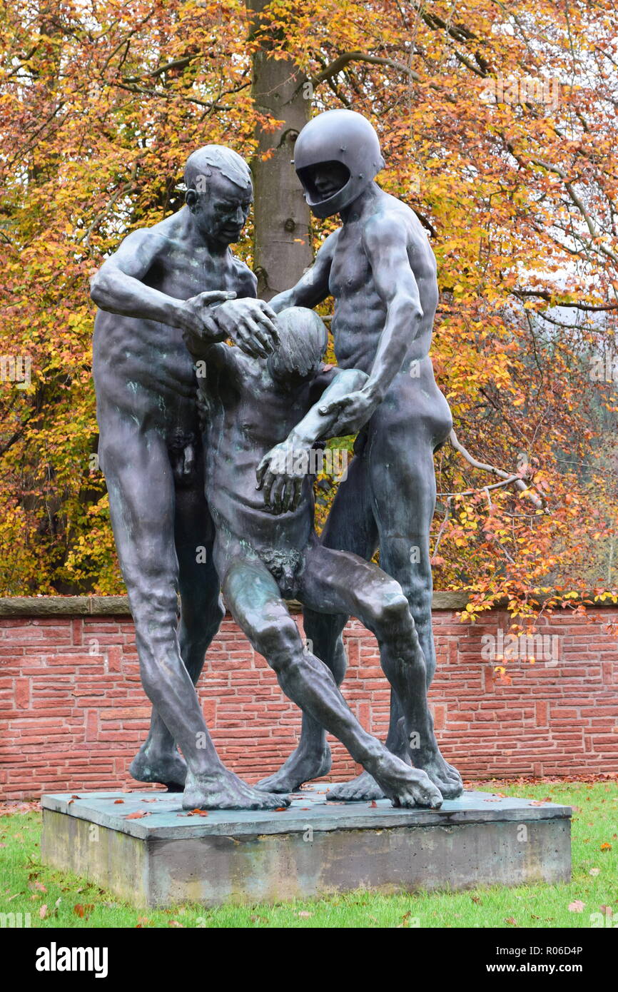 A bronze statue in Autumn in the War Cemetery in Reimsbach depicts two ...