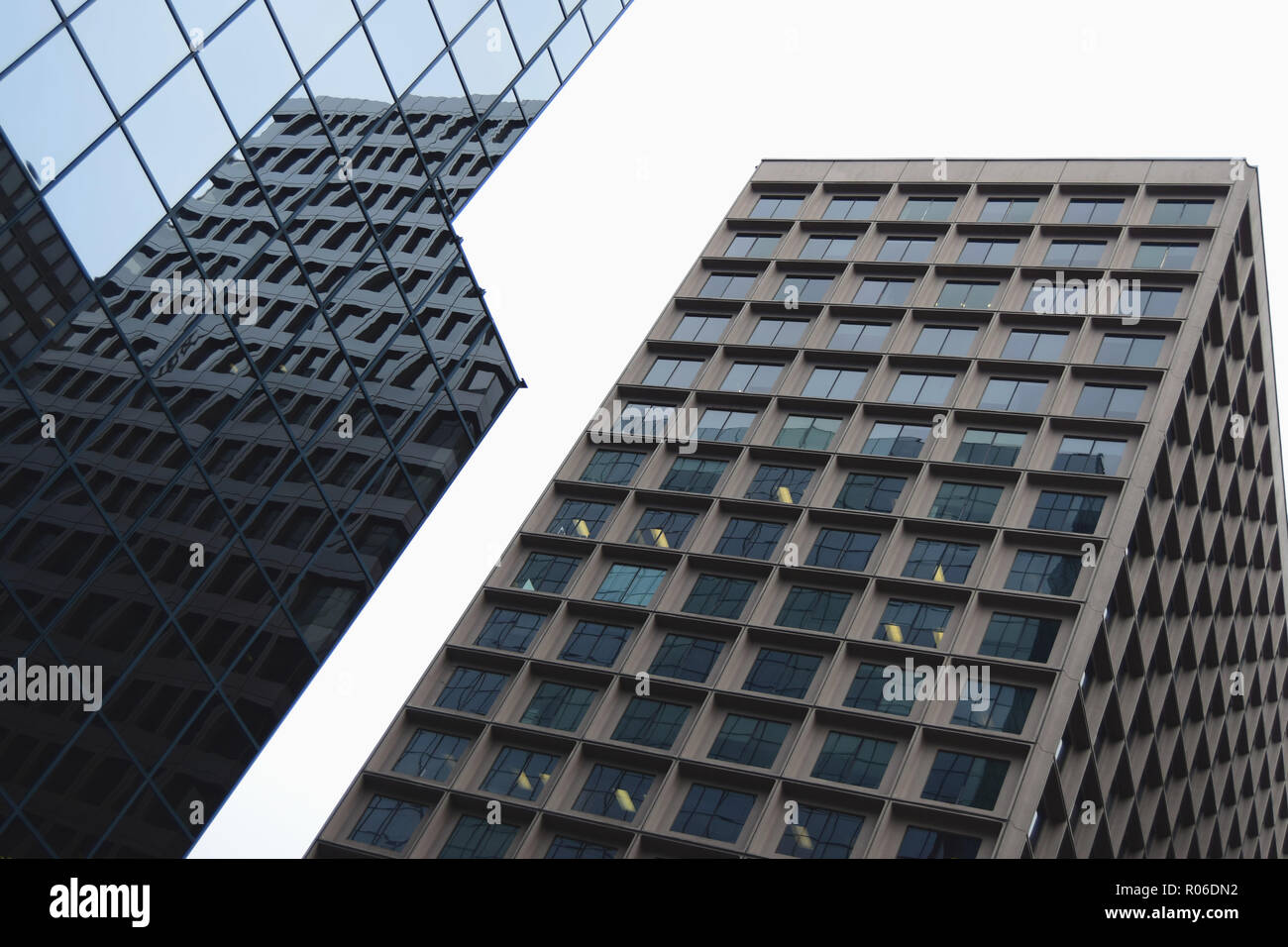 Building reflected on glass tower Stock Photo - Alamy