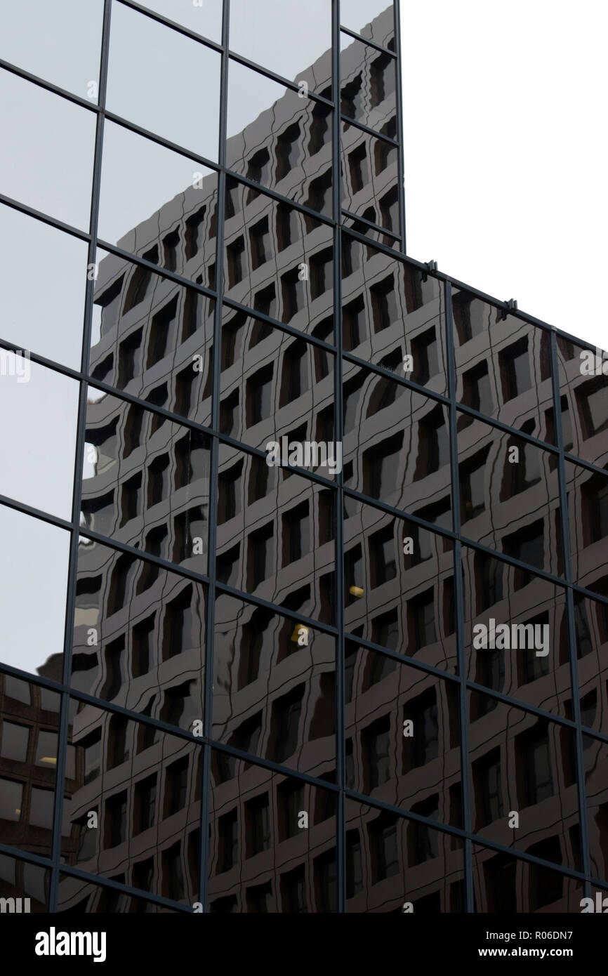 Building reflected on glass tower Stock Photo - Alamy