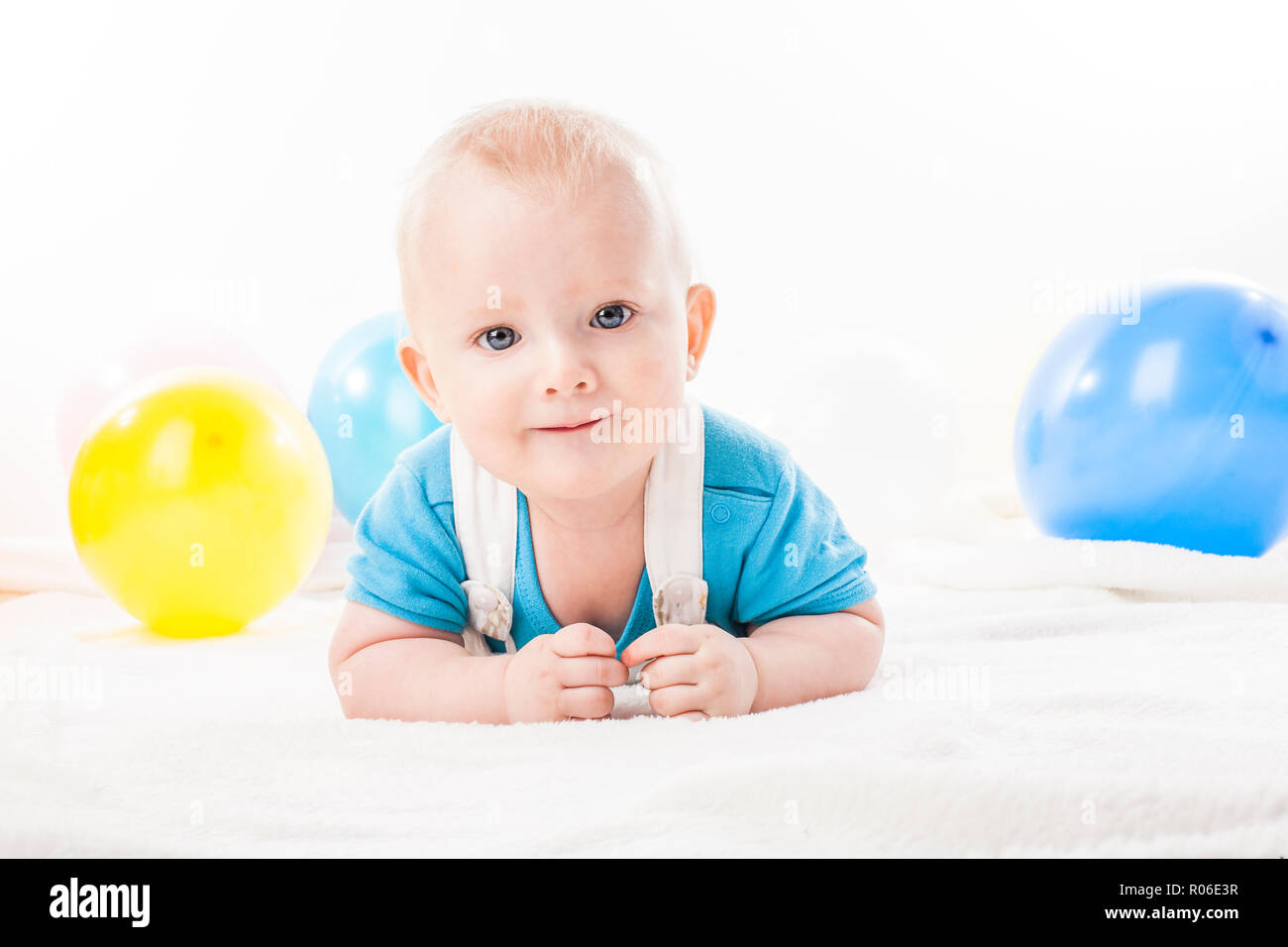 Baby with balloons on white background Stock Photo - Alamy