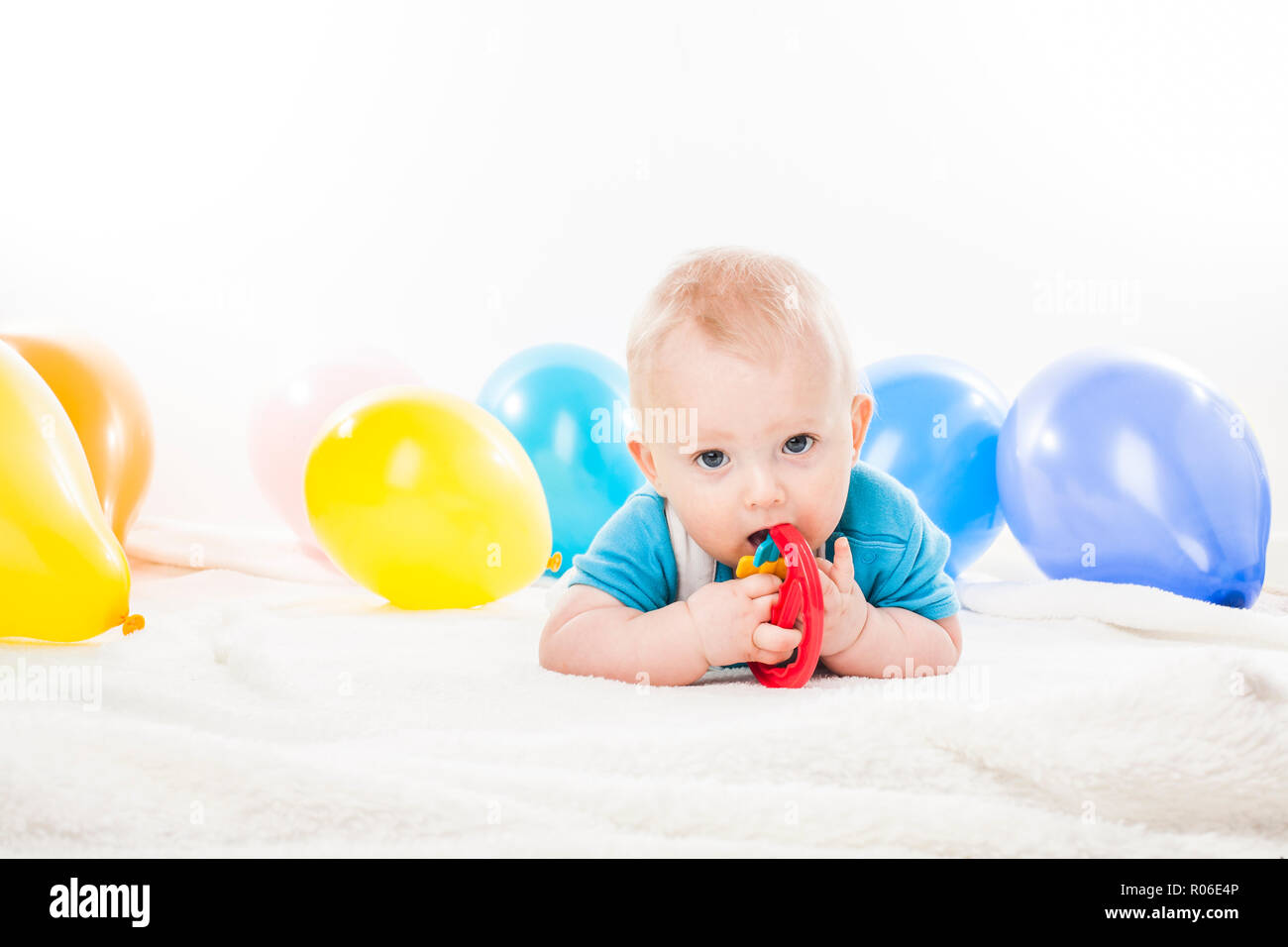 Baby with balloons on white background Stock Photo - Alamy