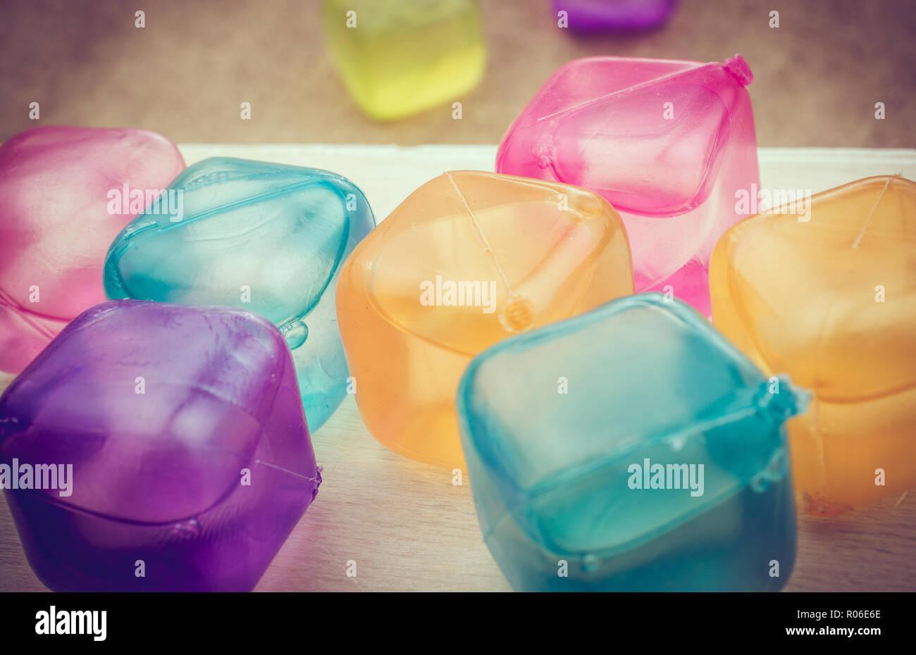 Fake colorful ice cubes on a brown background Stock Photo - Alamy
