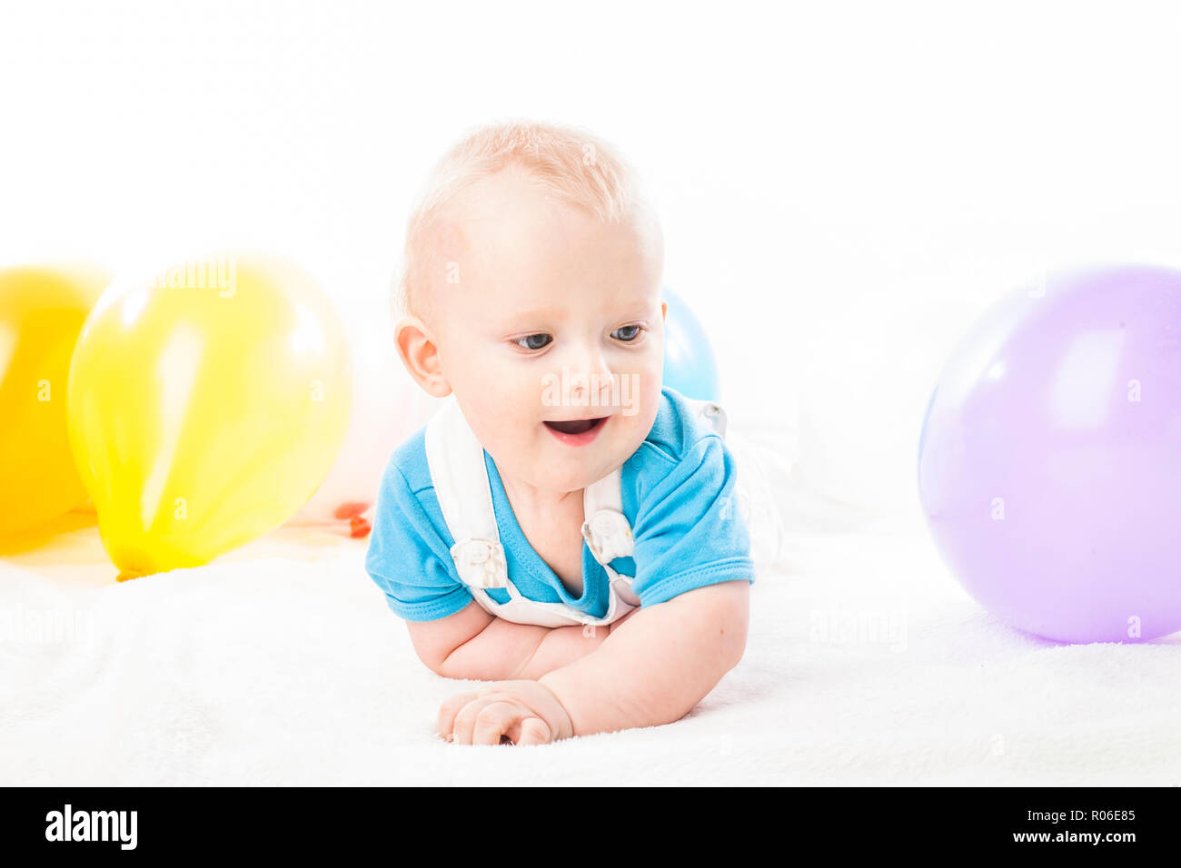Baby with balloons on white background Stock Photo - Alamy