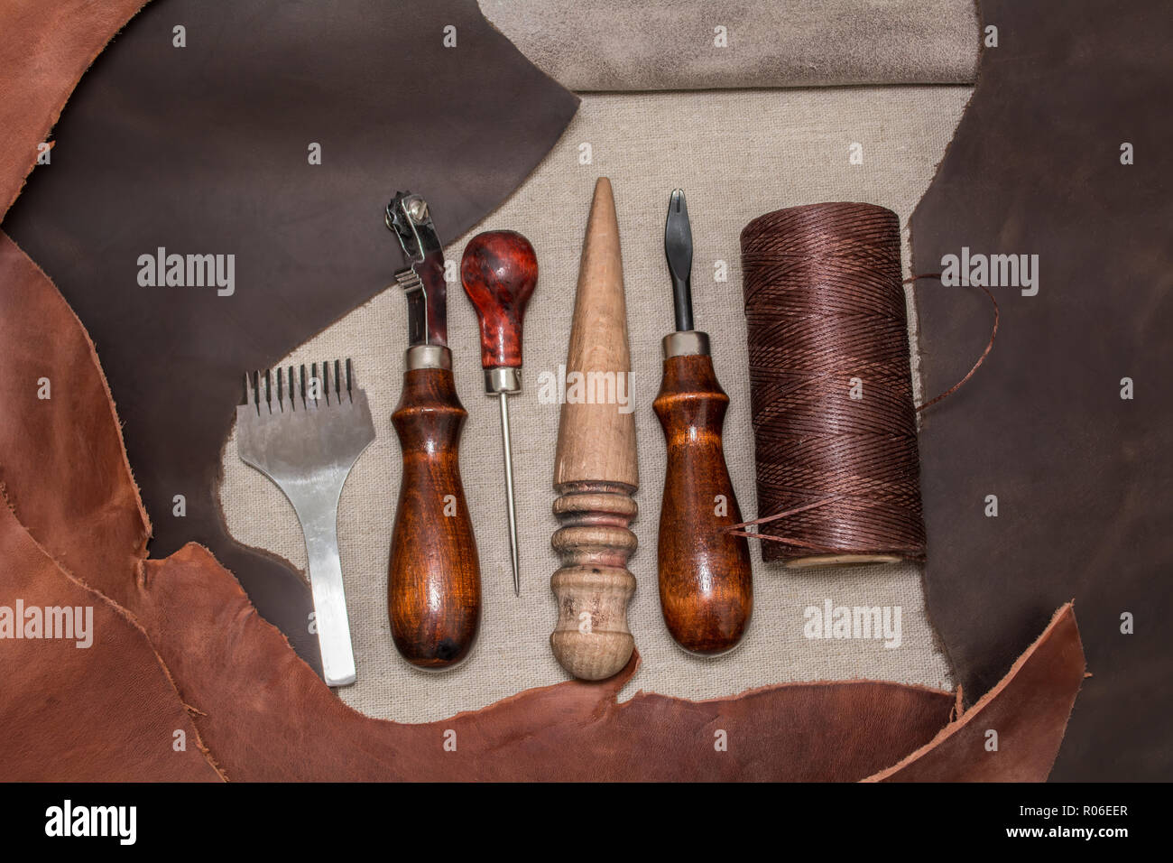 Tools for crafting and pieces of brown leather. Layout about ...