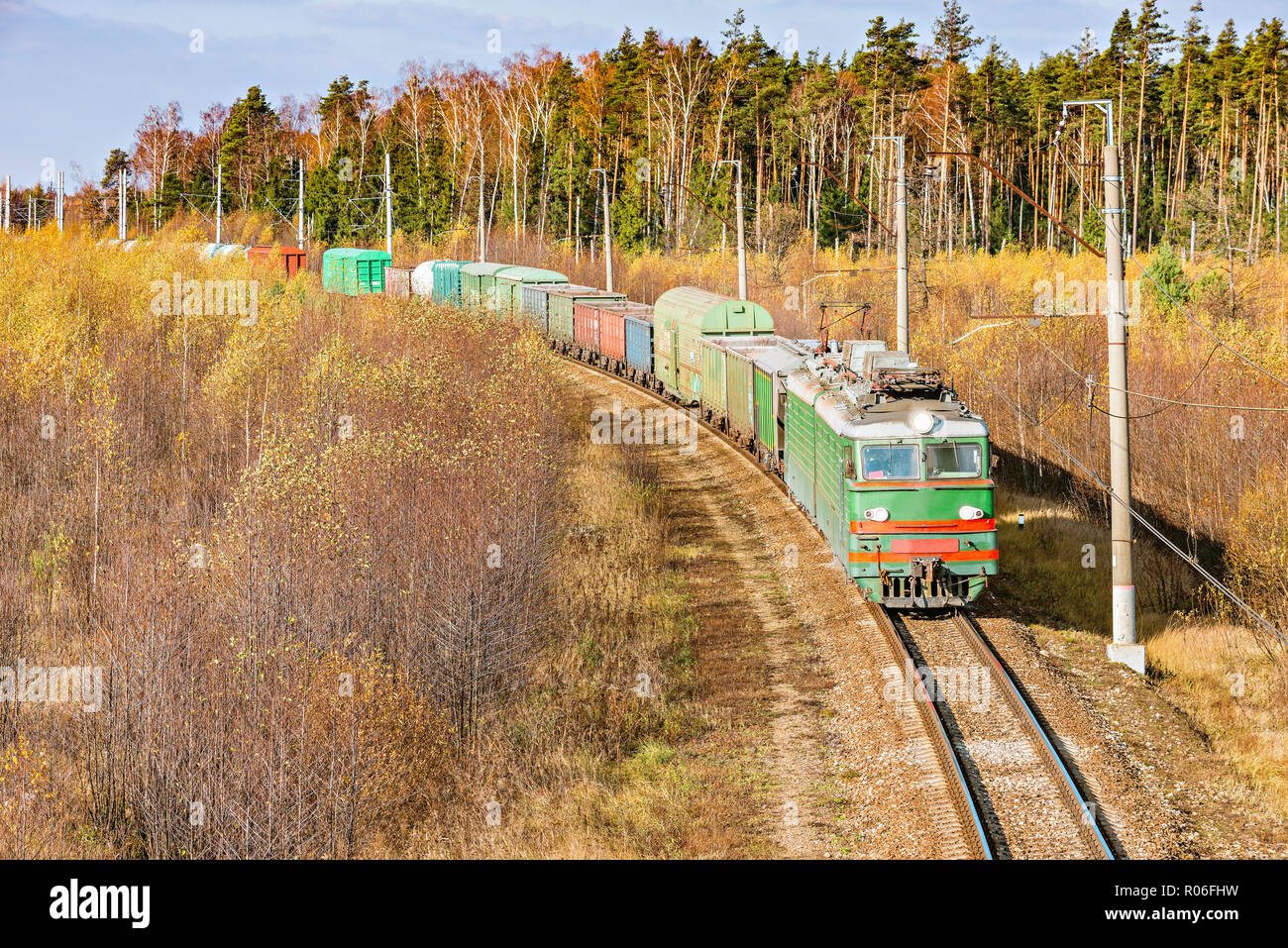Long freight train approaches to the station at autumn day time Stock ...