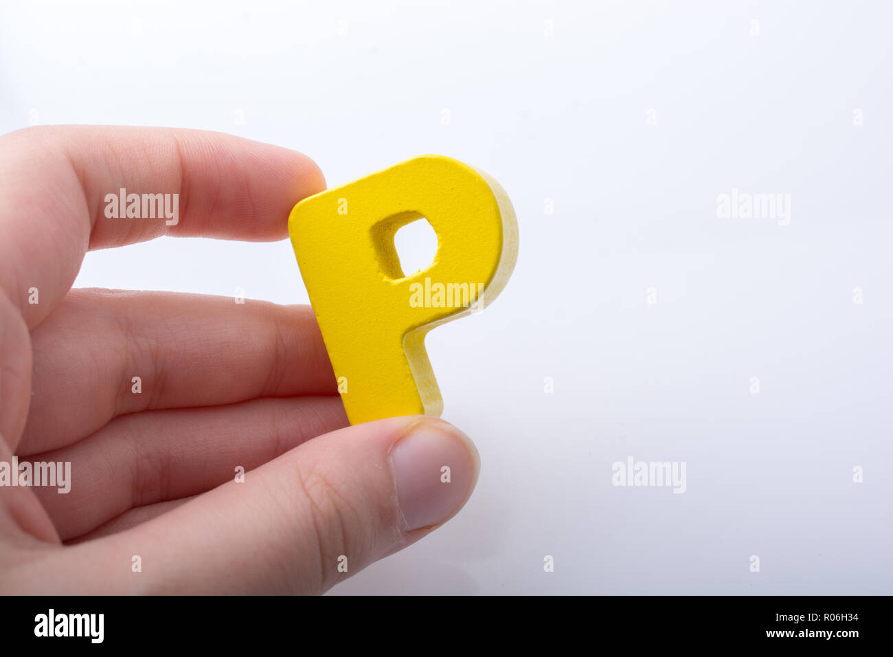 Hand holding letter cube P of made of wood Stock Photo - Alamy