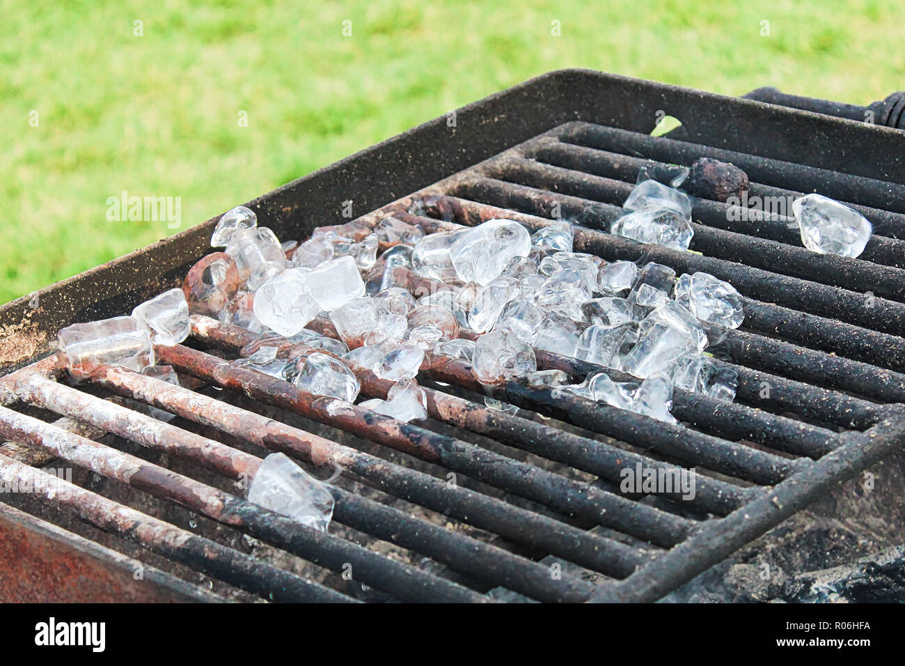 Ice cubes melting on a barbeque grill Stock Photo - Alamy