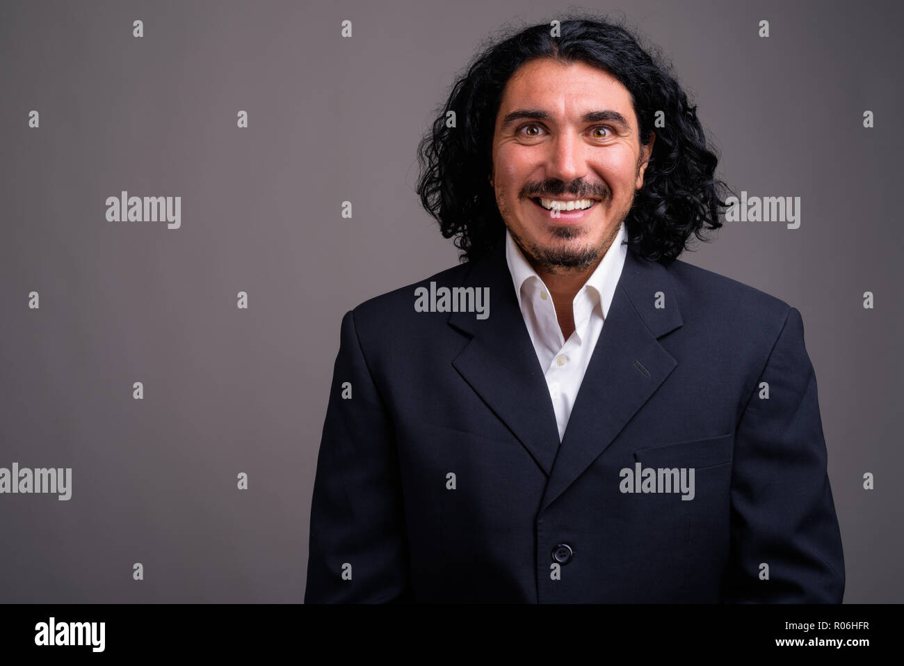 Handsome businessman with mustache wearing suit against gray bac Stock ...