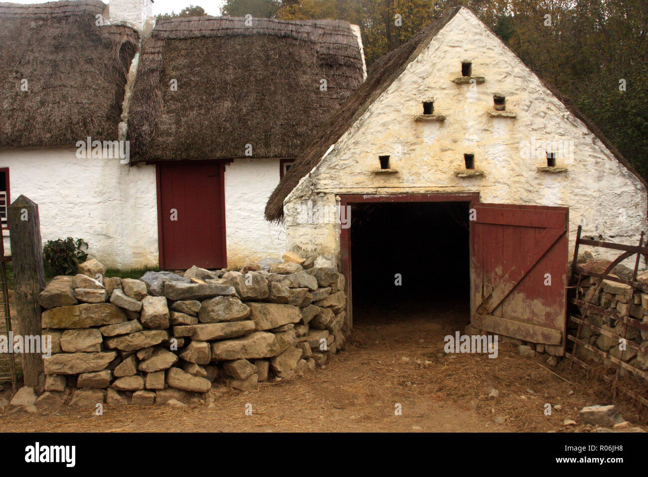 Old style pig's pen. House with thatched roof. Display of old 18th ...