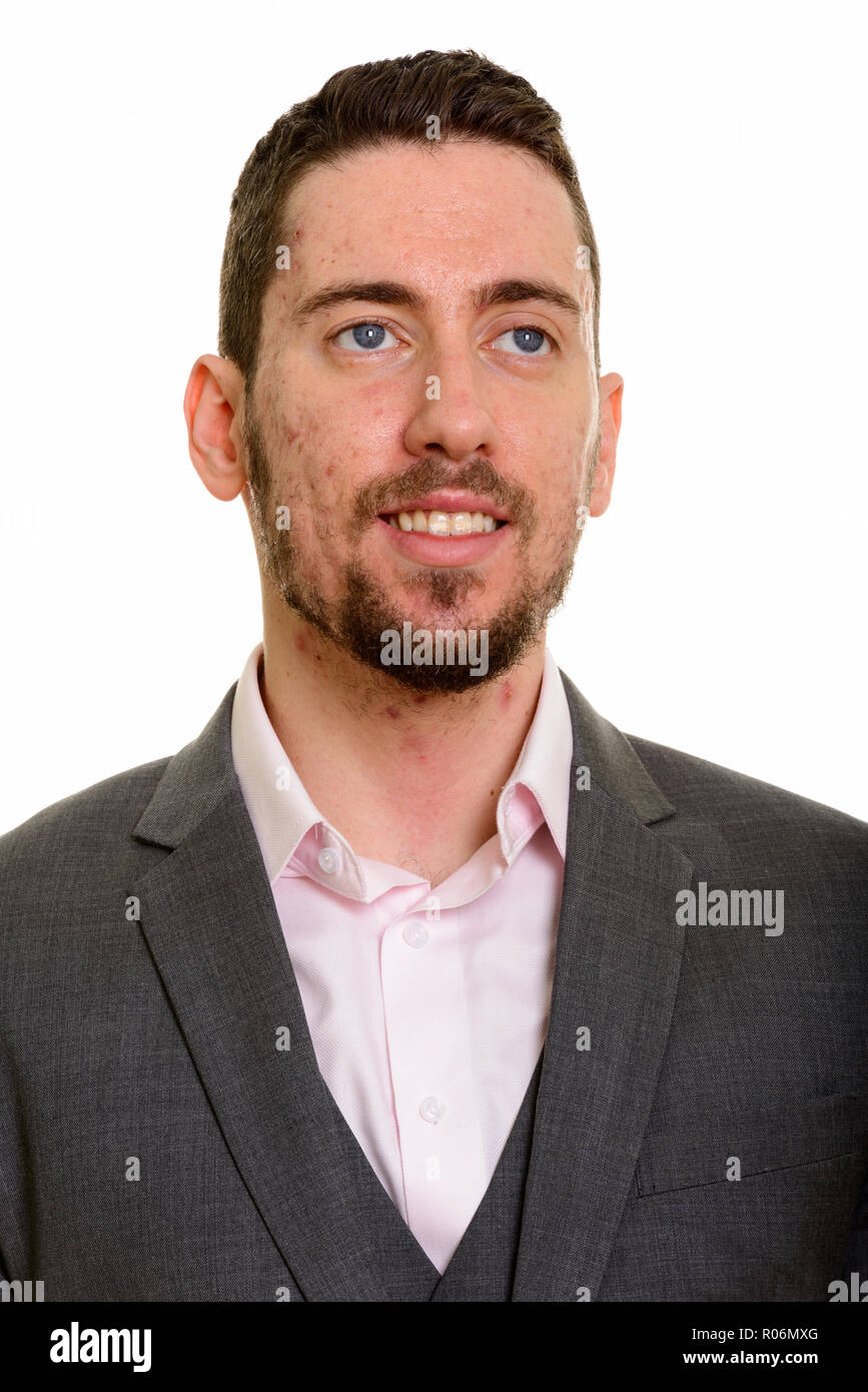 Young happy Caucasian businessman smiling and thinking Stock Photo - Alamy