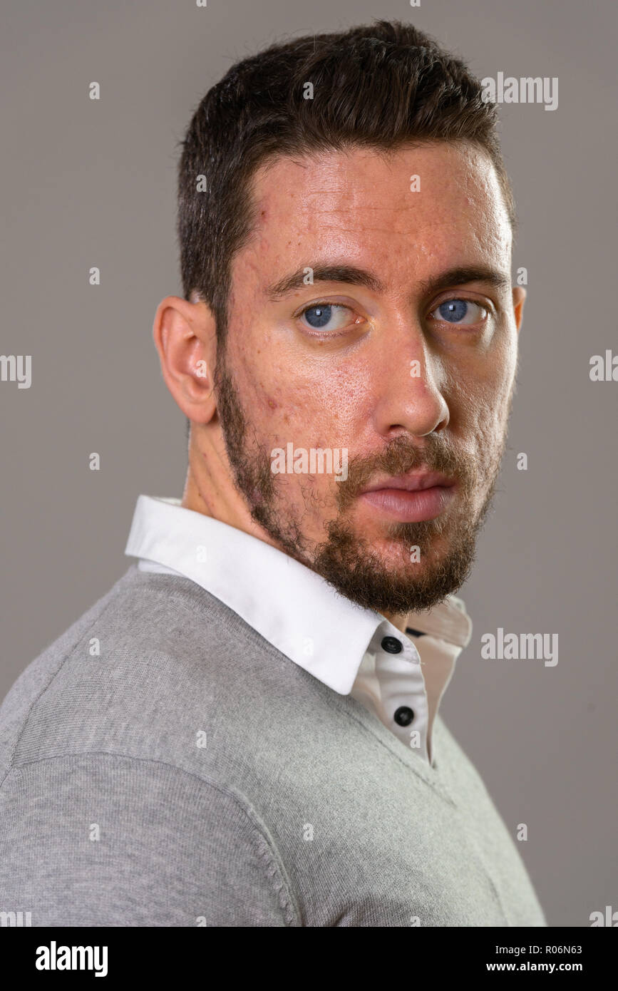 Face of young handsome Caucasian man thinking Stock Photo - Alamy