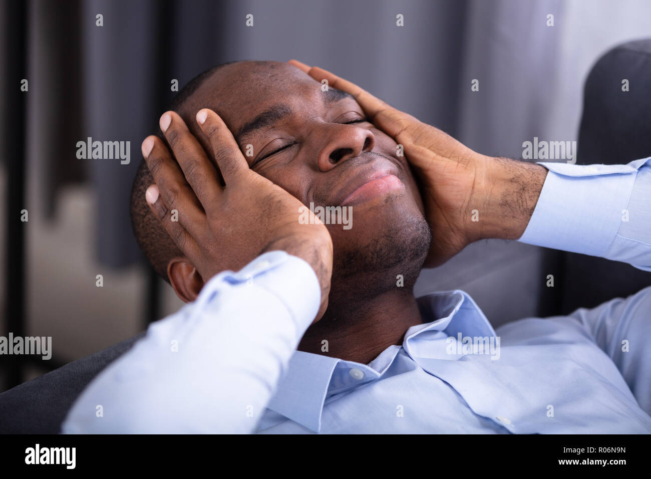 Close-up Of A Stressed Young Man With Hand On His Face Stock Photo - Alamy