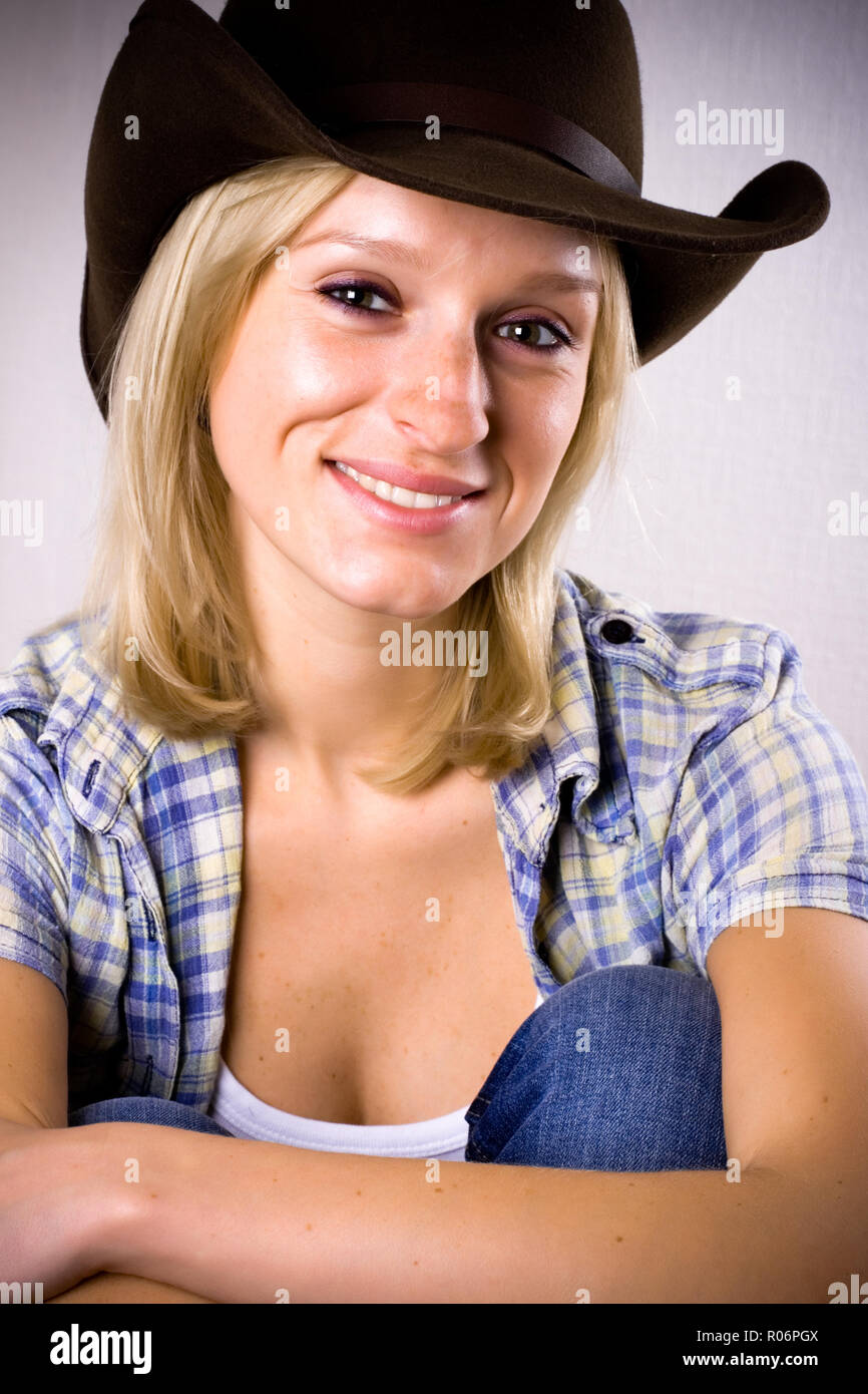 pretty western woman in cowboy shirt and hat isolated on white ...