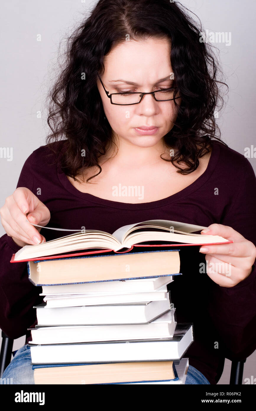 portrait of attractive woman with stack of books Stock Photo - Alamy
