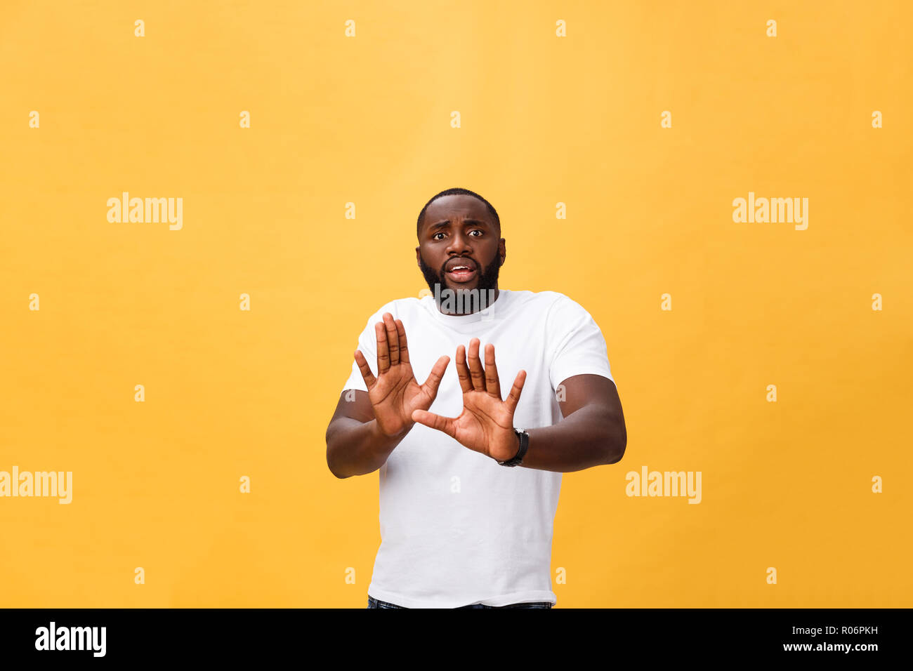 Portrait shock and annoyed displeased young man raising hands up to say ...