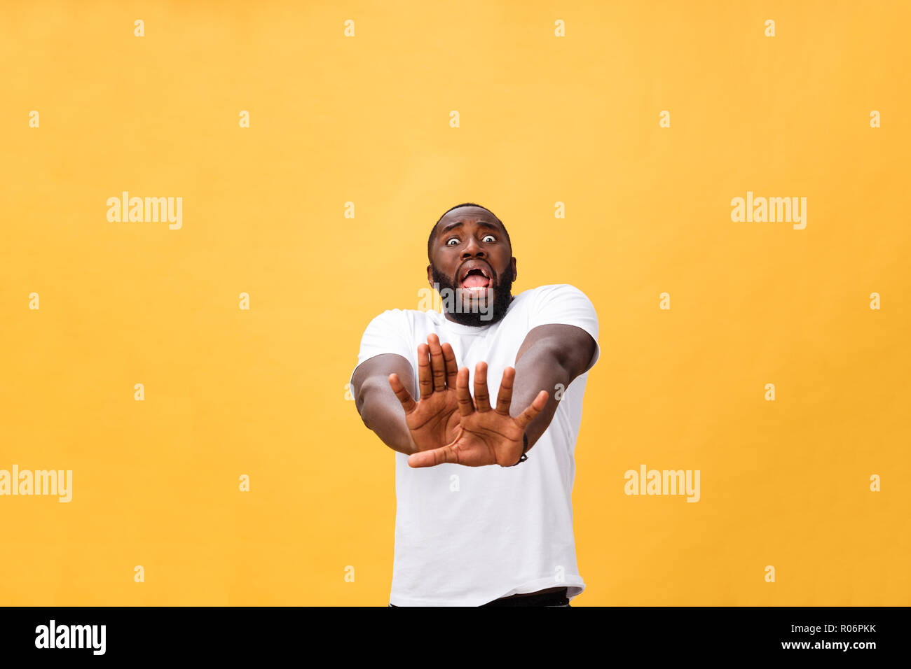 Portrait shock and annoyed displeased young man raising hands up to say ...