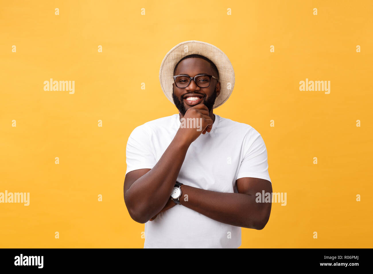 Single handsome muscular Black man with shaved head, folded arms and ...