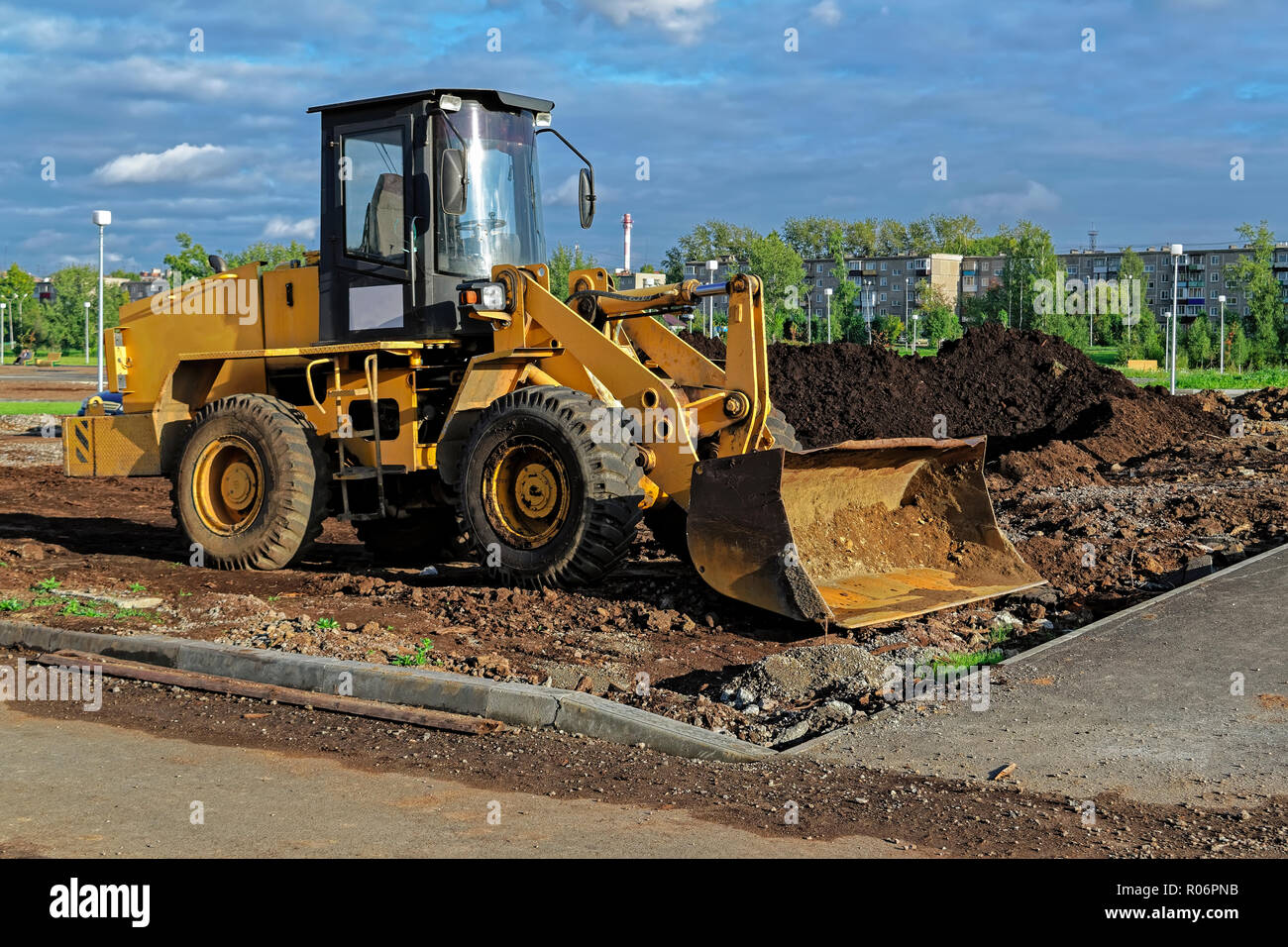 The yellow Tractor at a construction site Stock Photo - Alamy