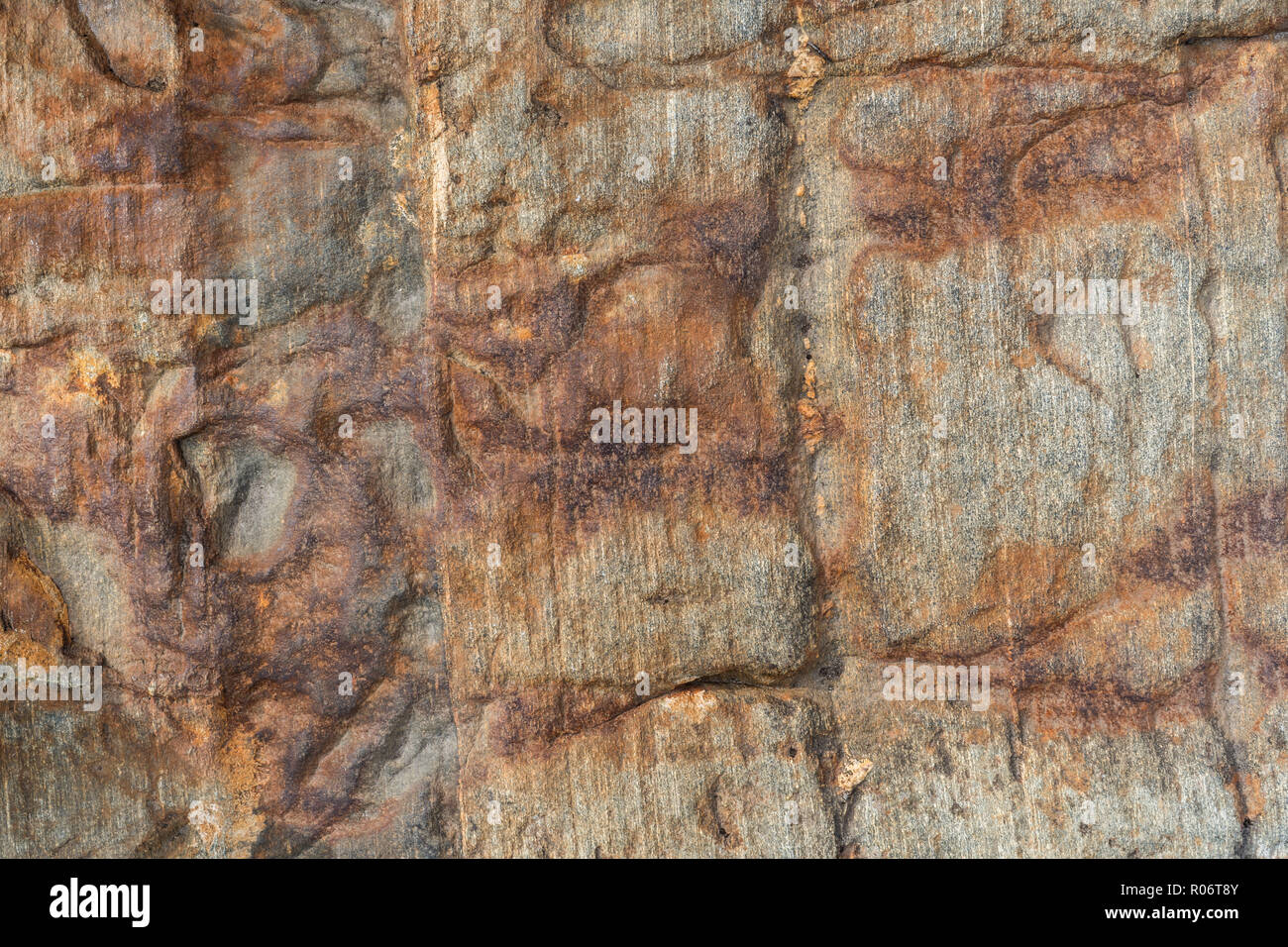 Oxidized brown and grey rock texture weathered by natural forces wind ...