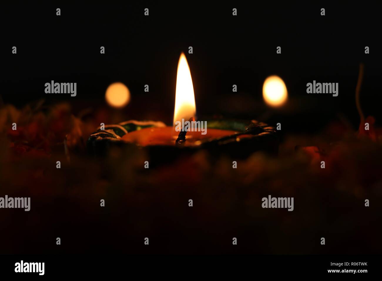 Isolated diya decorated with flowers for the celebration of diwali and ...