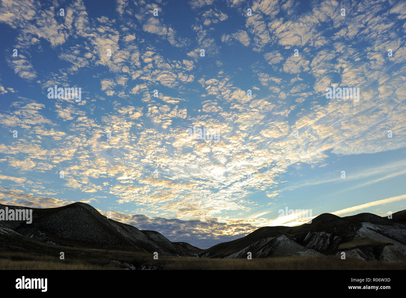 Mountain peaks and blue sky. Clouds at dawn in sun. Landscape natural ...