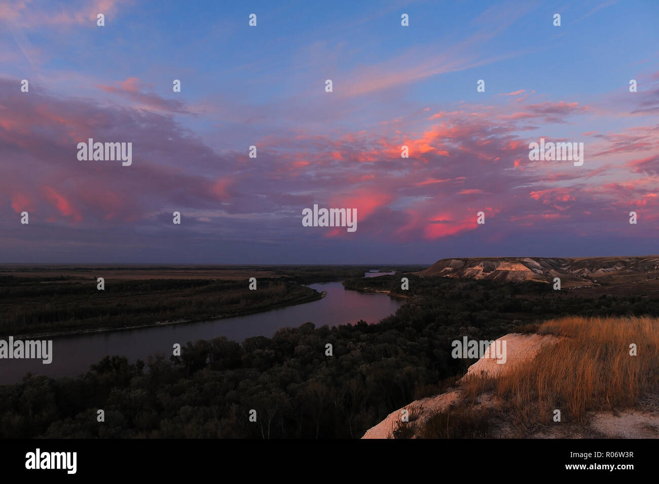 Vanilla sunset on the river. Autumn landscape. Beautiful clouds and ...