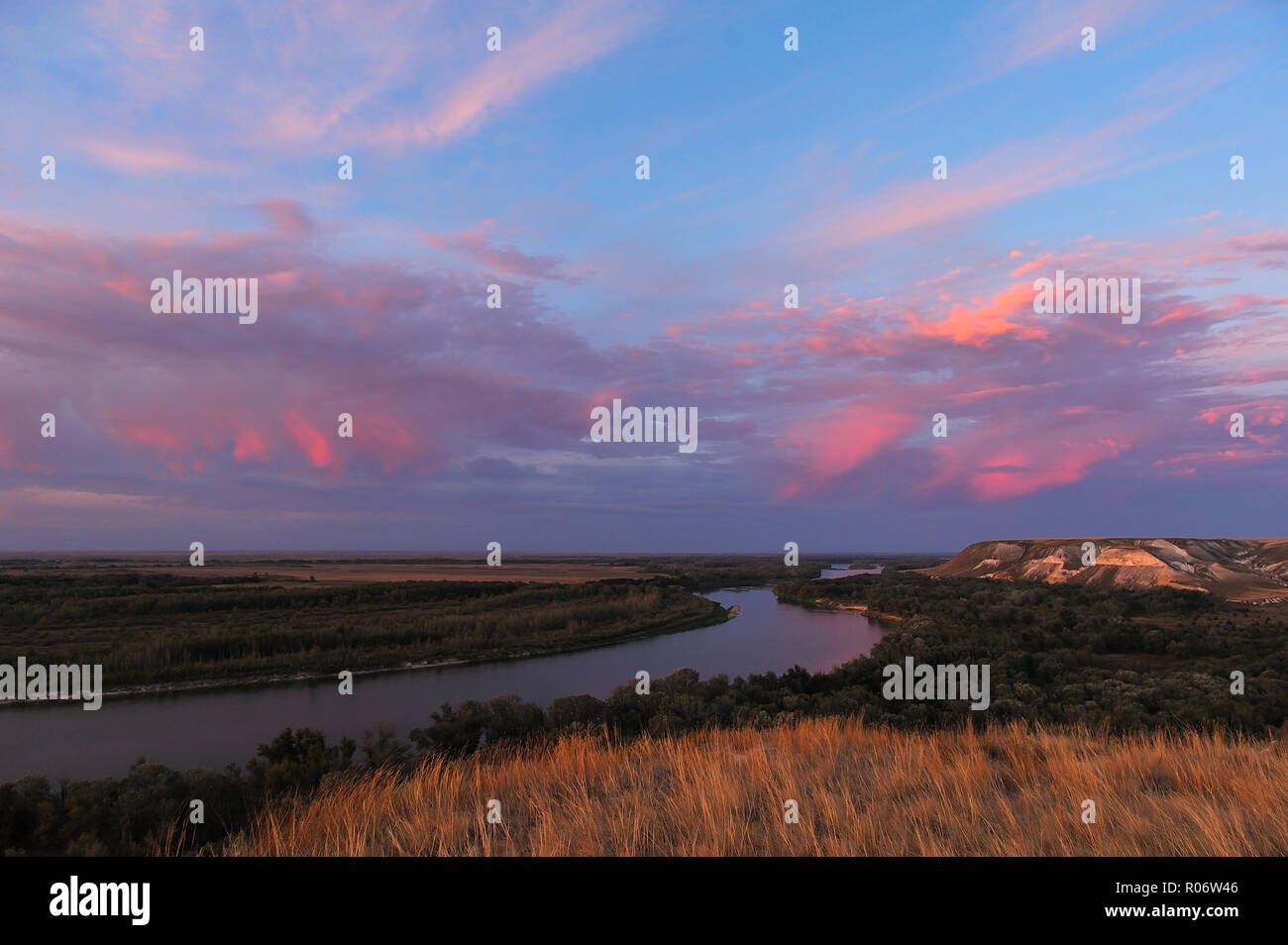Vanilla sunset on the river. Autumn landscape. Beautiful clouds and ...
