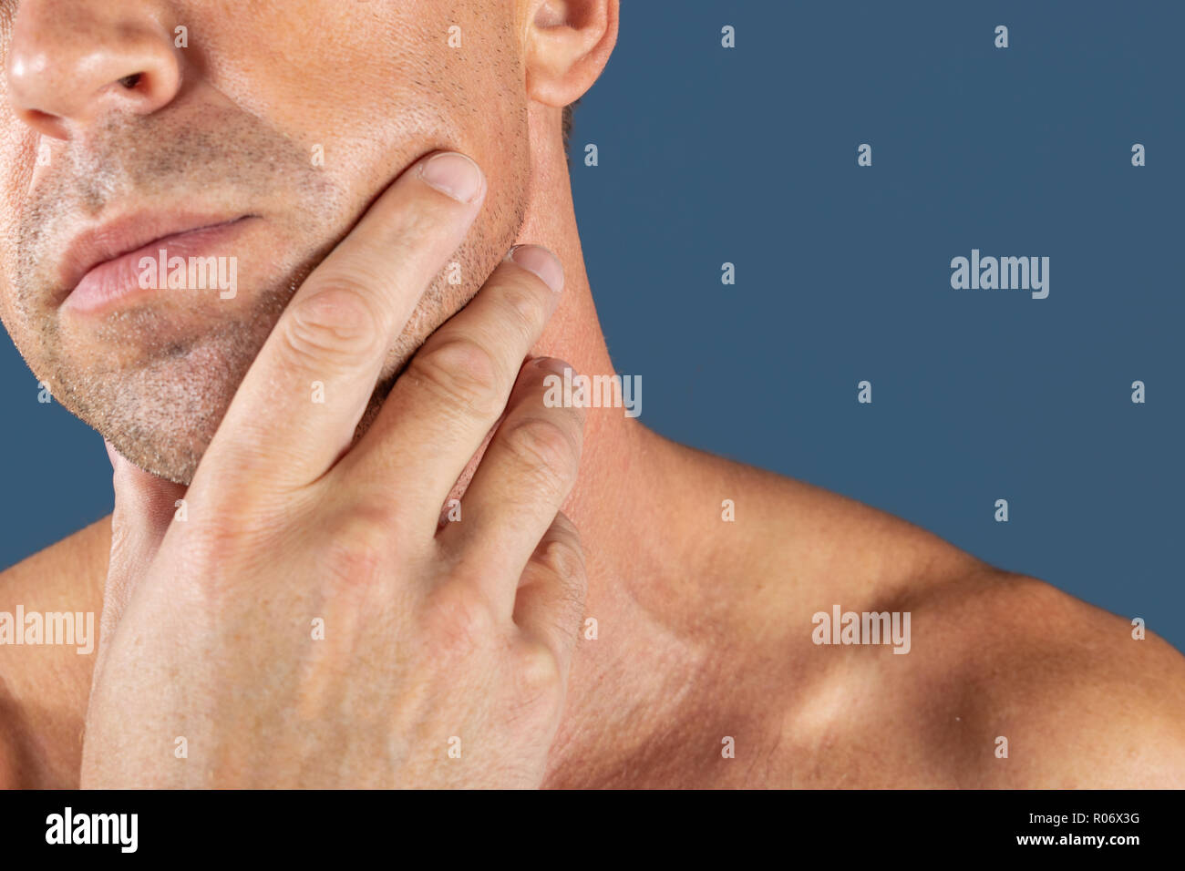 Mature caucasian man touching cheek hi-res stock photography and images ...