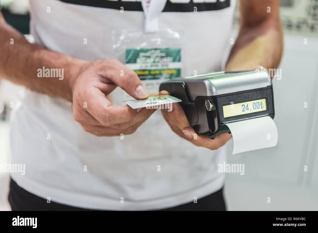 Caucasian seller man holding card machine or POS terminal in his hands ...
